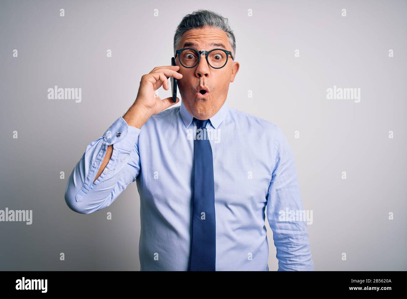 Middle age handsome grey-haired business man having conversation ...