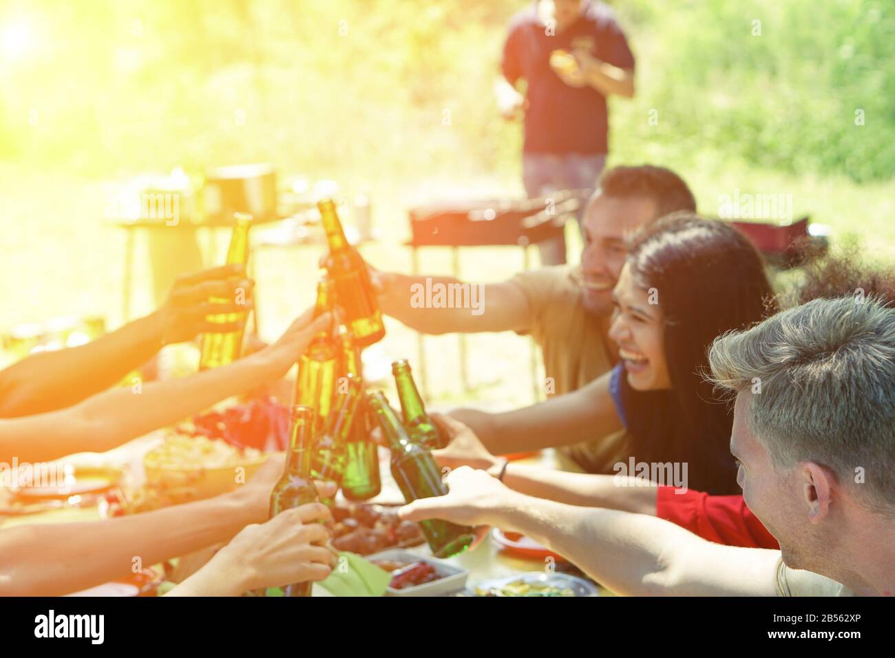 Group of multiracial students having barbecue on a sunny day - Young ...