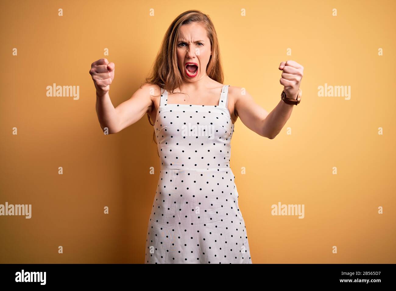 Young beautiful blonde woman on vacation wearing summer dress over ...
