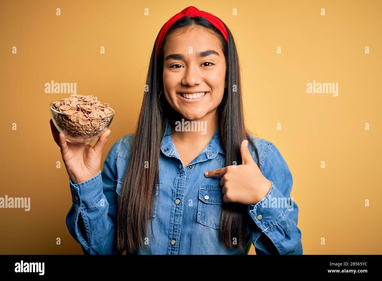Beautiful asian woman holding bowl with healthy corn flakes cereals ...
