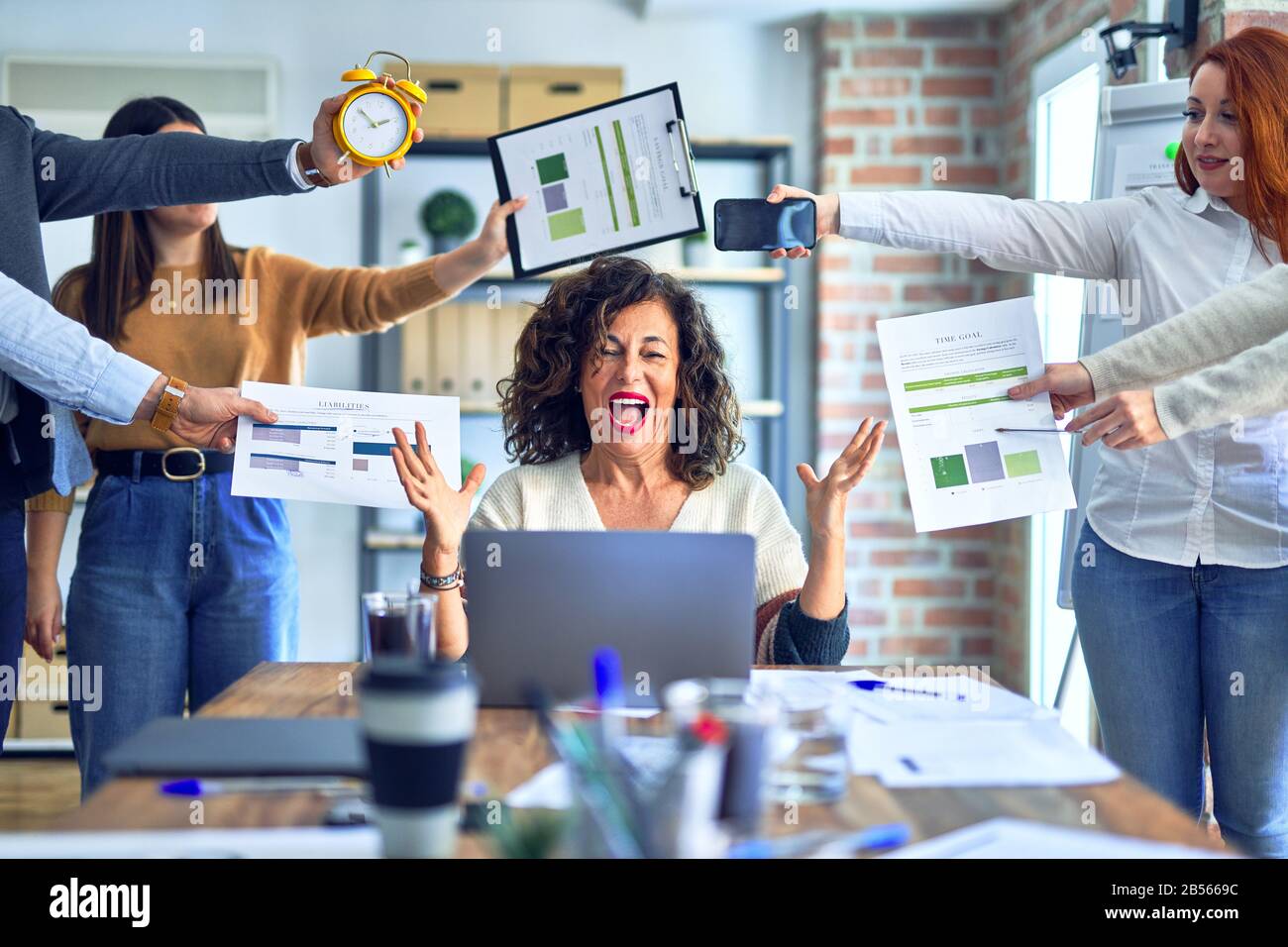 Group of business workers working together. Partners stressing one of ...