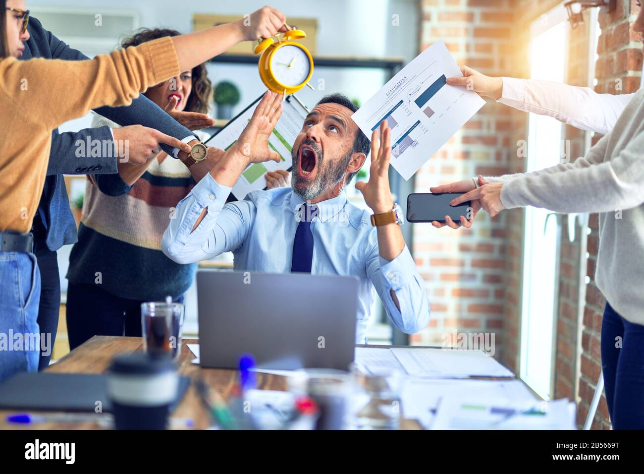 Group of business workers working together. Partners stressing one of ...