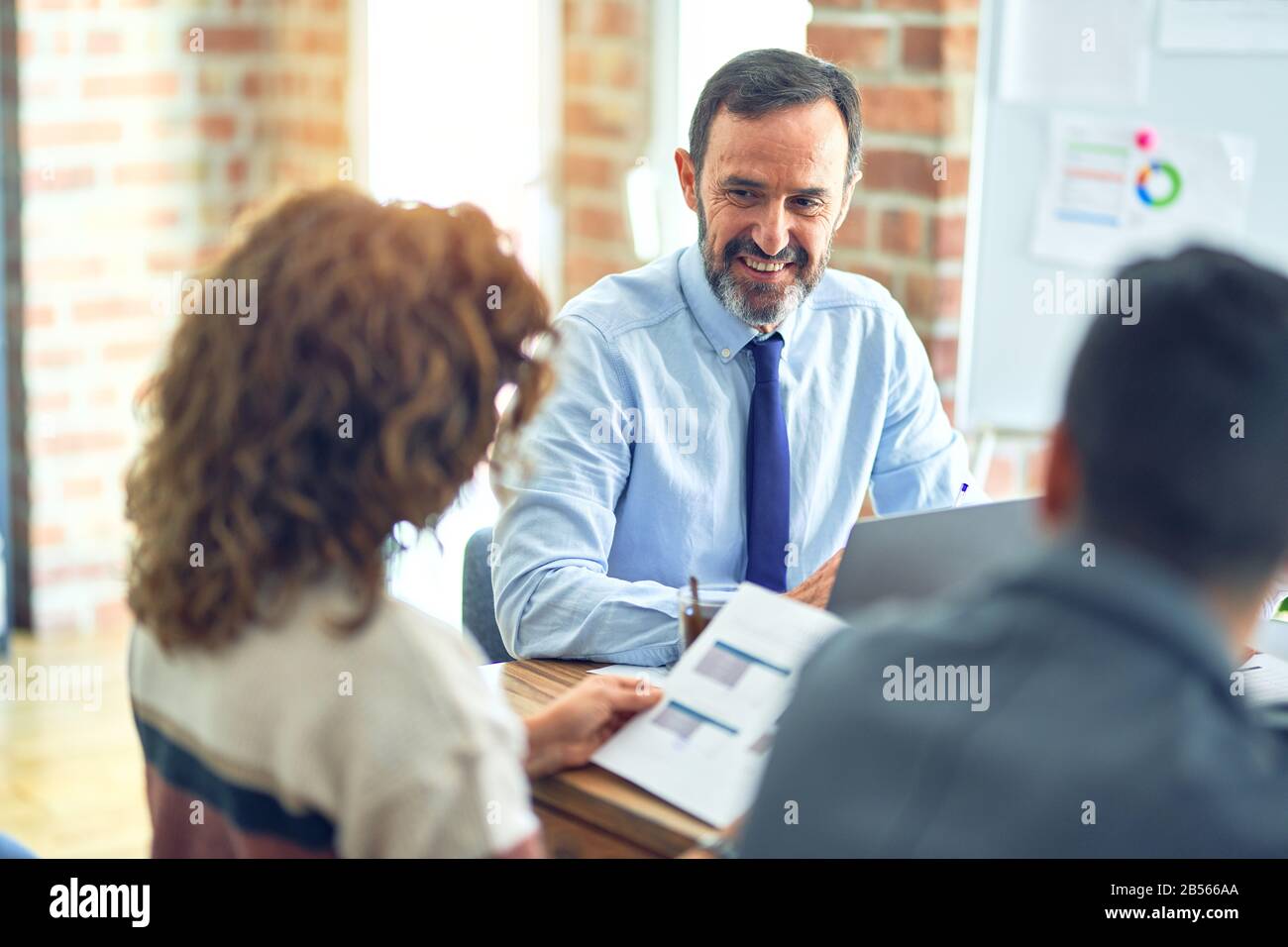 Group of business workers smiling happy working together. Sitting on ...