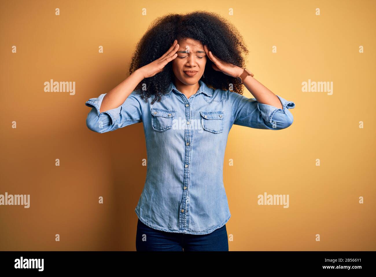 Young beautiful african american woman with afro hair standing over ...