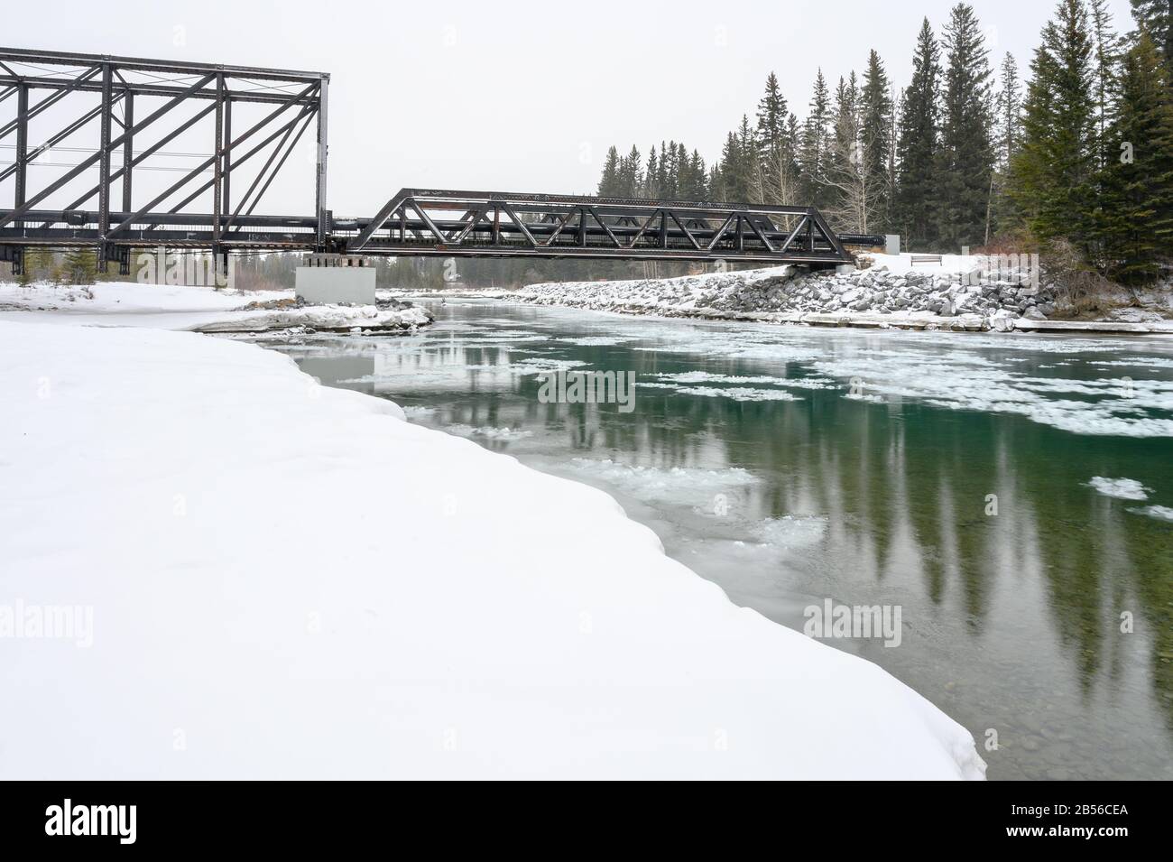 Snowy day at Engine Bridge pedestrian crossing over the Bow River in ...