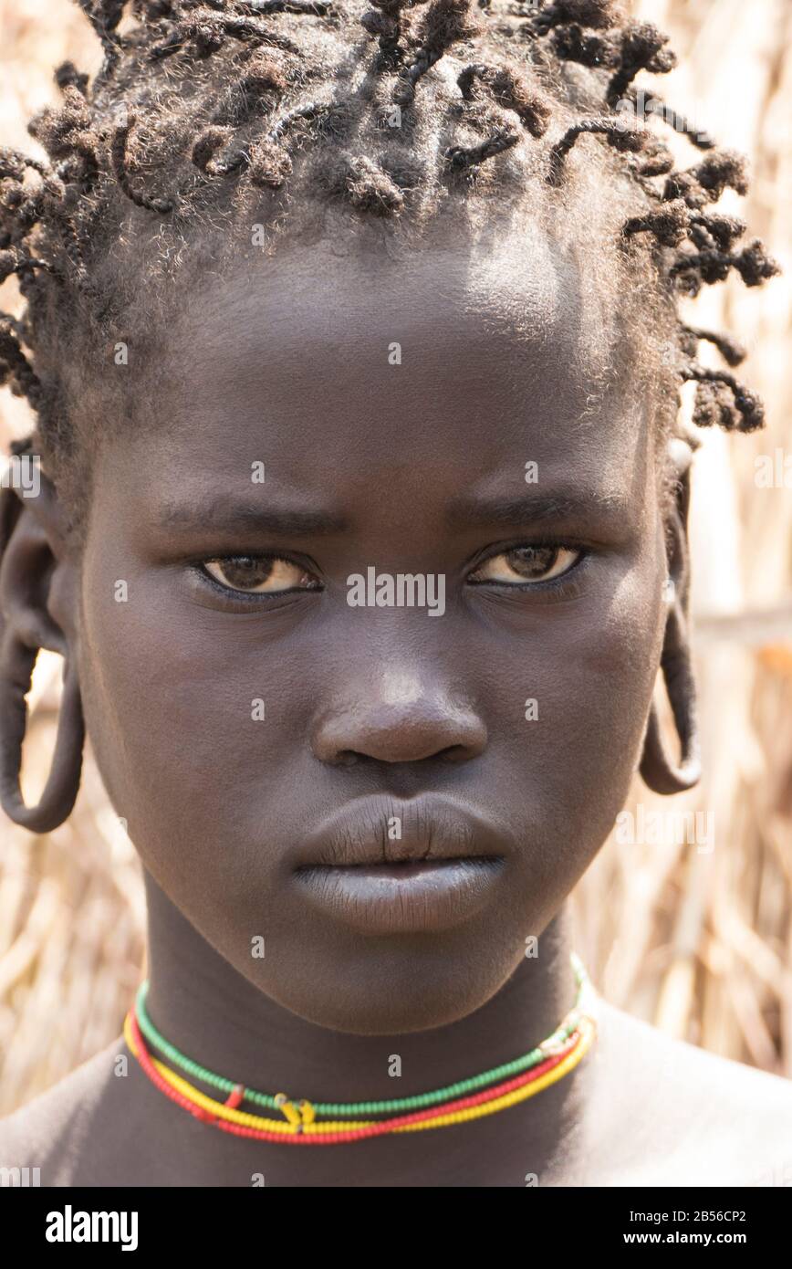 A Head Shot of a Mursi Tribe (Ethnic Group) Young Woman in the Omo ...