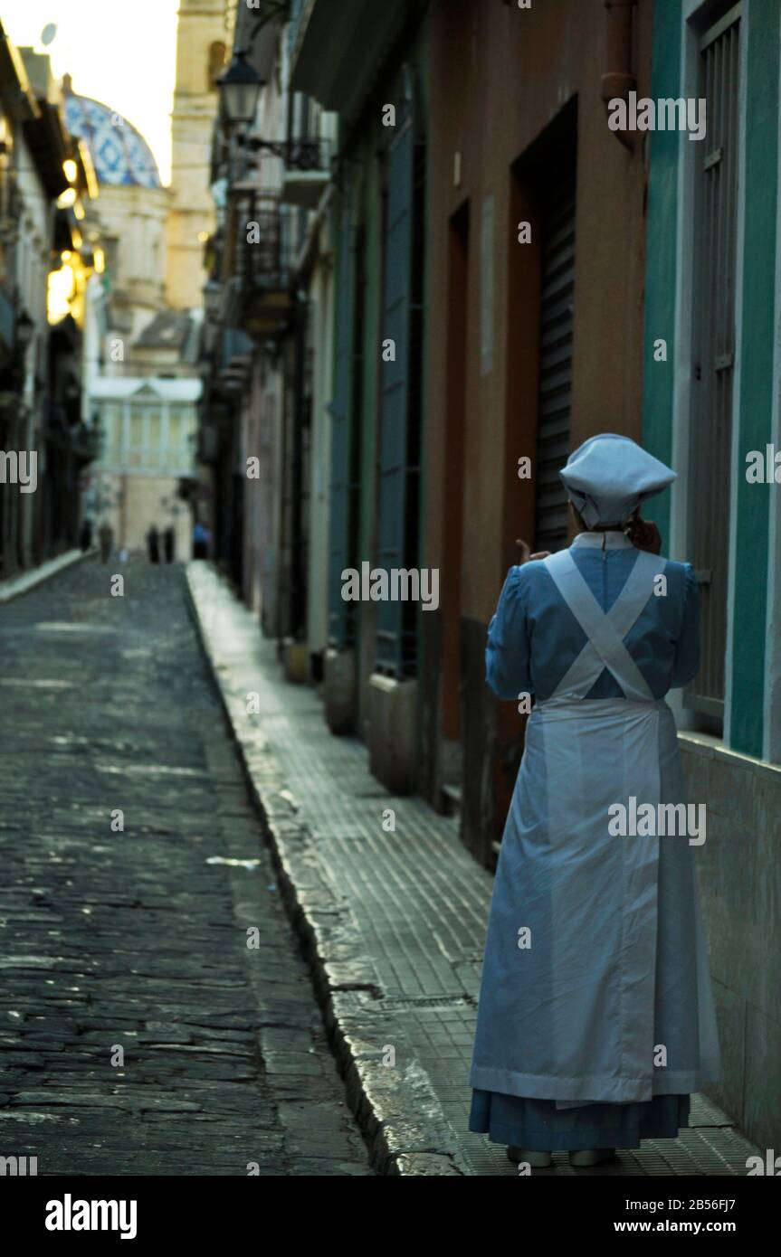 Woman wearing the outfit that nurses wore in ancient times. Nurse in a ...