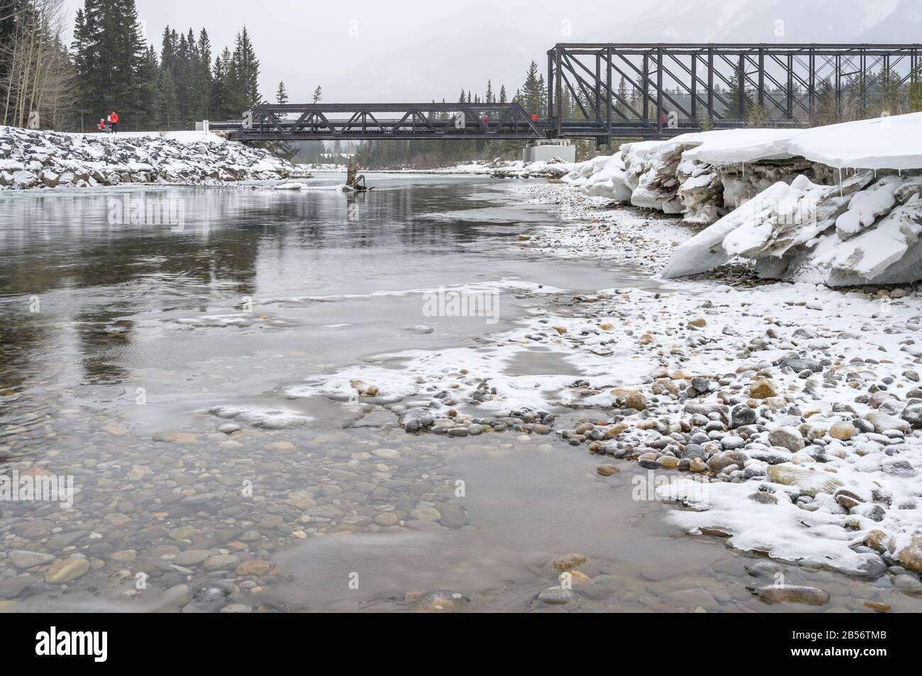 Snowy day at Engine Bridge pedestrian crossing over the Bow River in ...