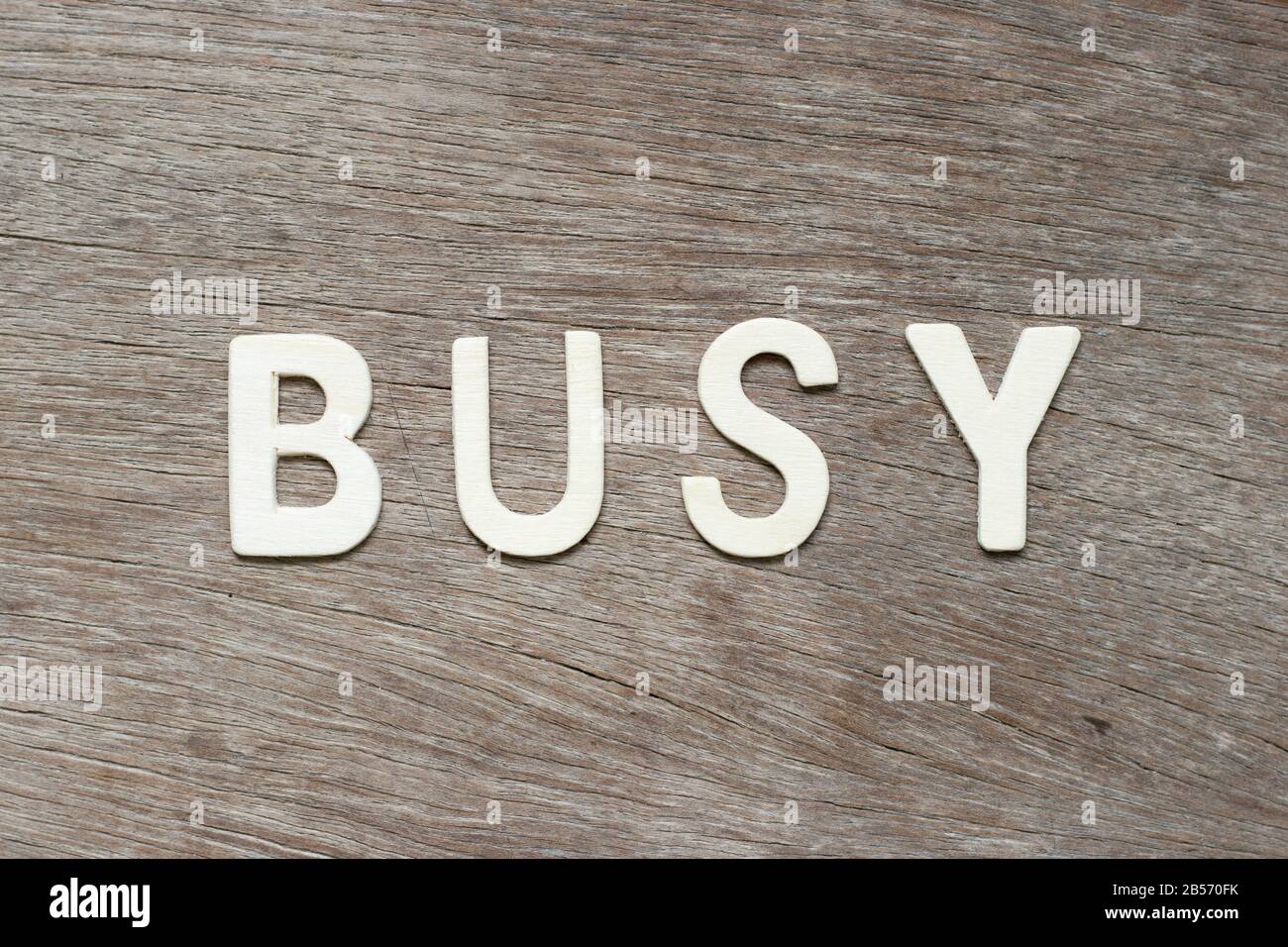 Alphabet letter in word busy on wood background Stock Photo - Alamy