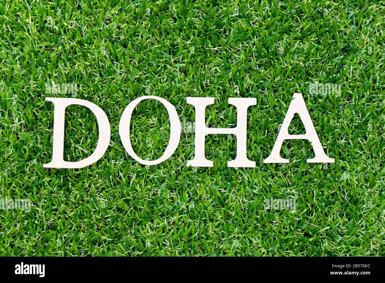 Wood letter in word doha on green grass background Stock Photo - Alamy