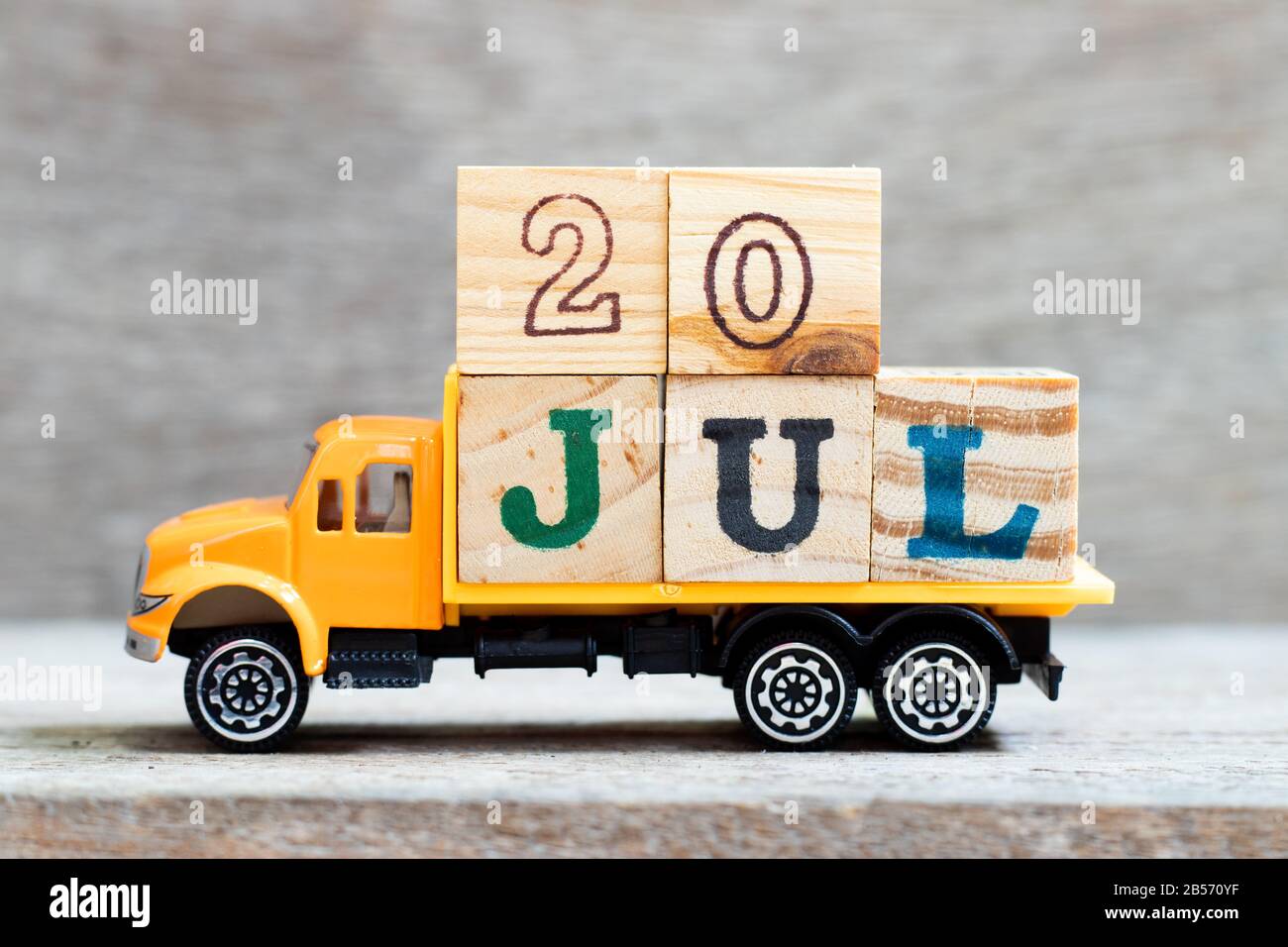 Truck hold letter block in word 20jul on wood background (Concept for ...
