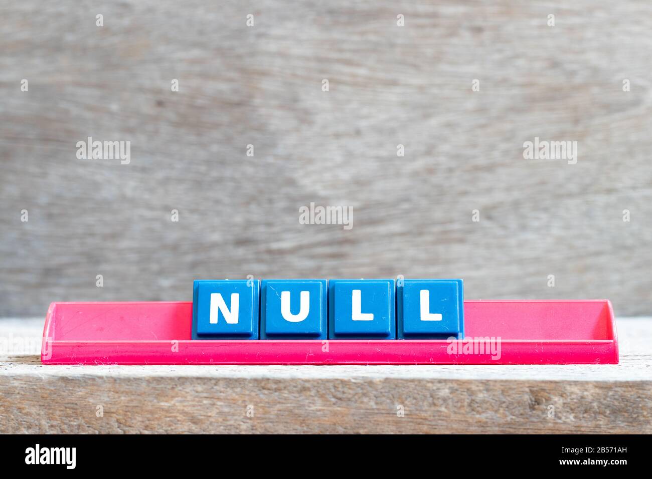 Tile letter on red rack in word null on wood background Stock Photo - Alamy
