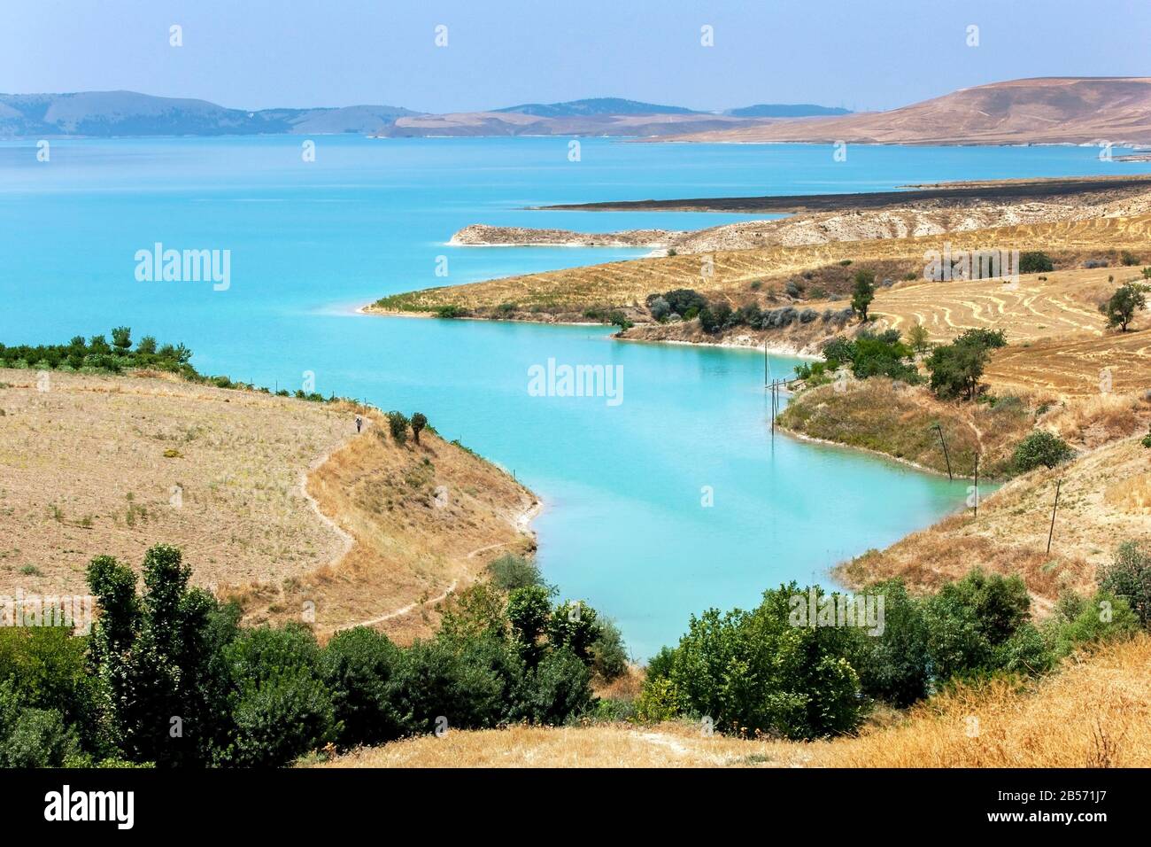 Recently harvested paddocks of grain crops sit adjacent to Ataturk Dam ...