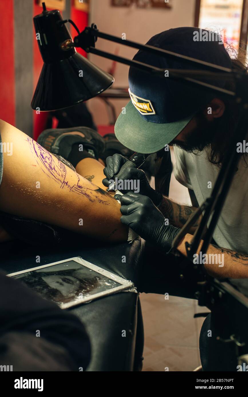 Tattoo artist workplace with machine and bottles with black tattoo ink ...