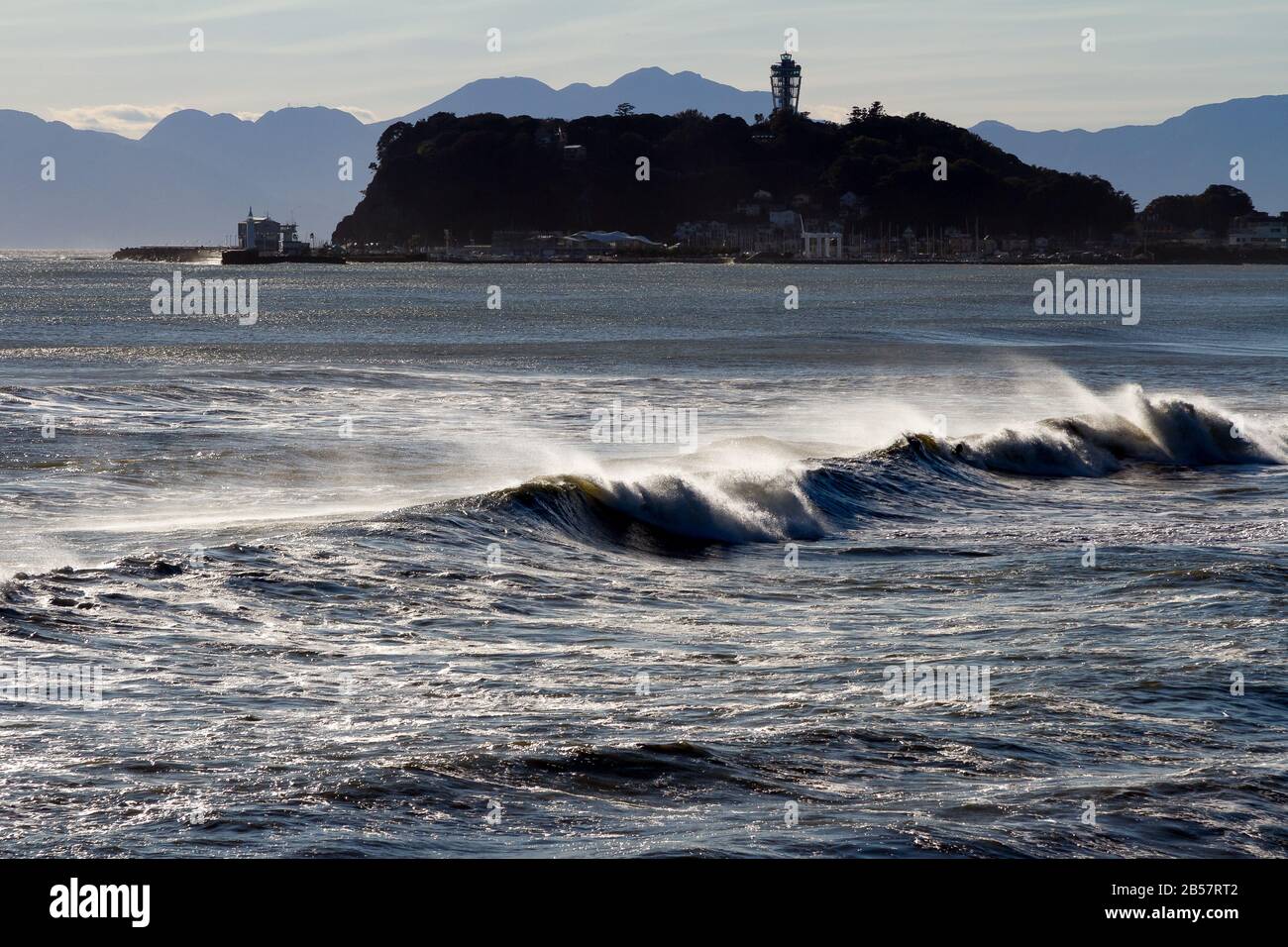 Enoshima Island seen above waves on Enoshima Beach Kanagawa, Japan ...