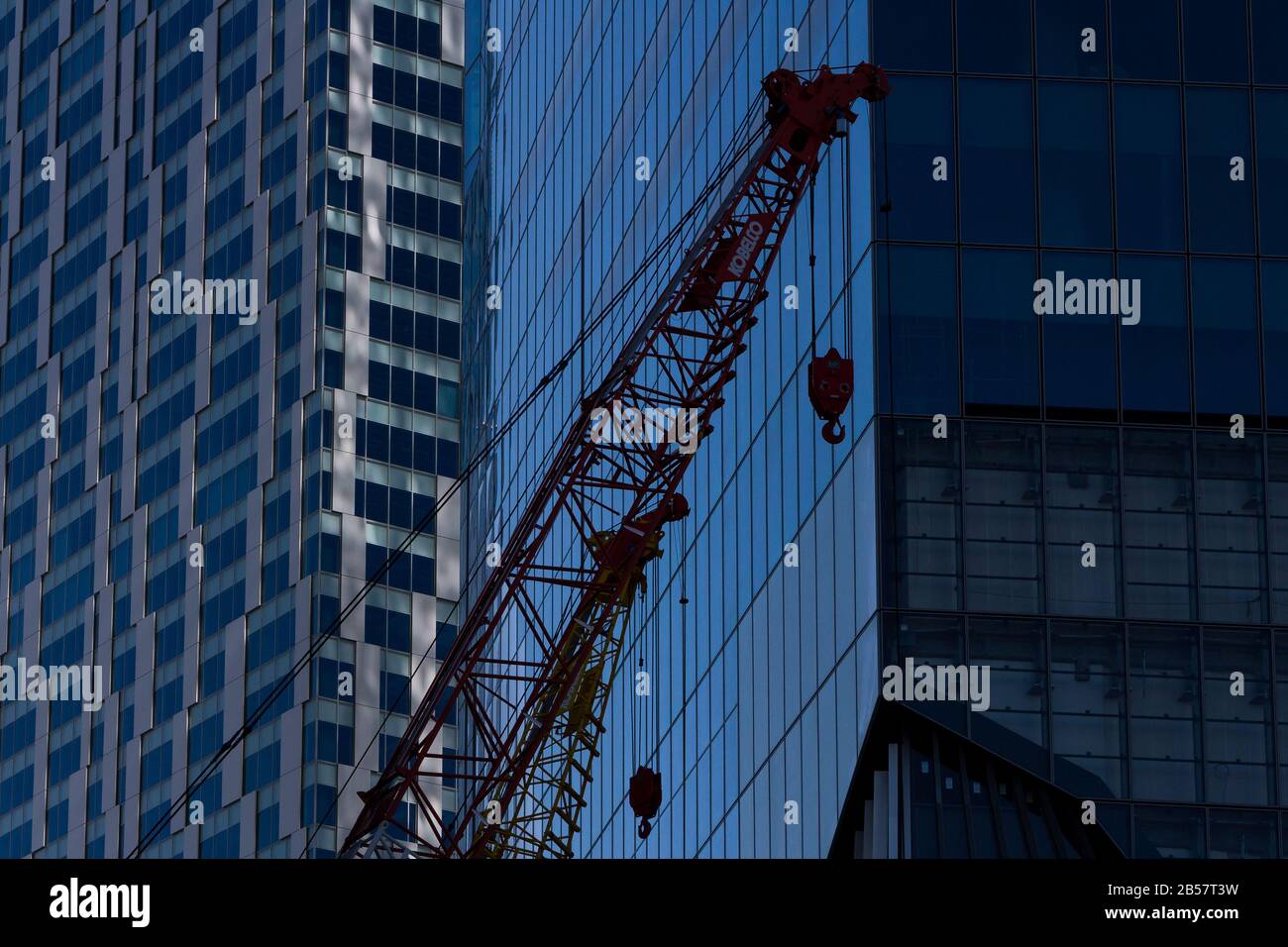 Silhouette of cranes in front of the towers of the Shibuya Stream ...