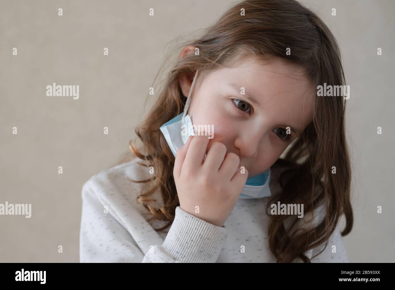 cute little sick sad girl in medical mask during virus epidemic ...