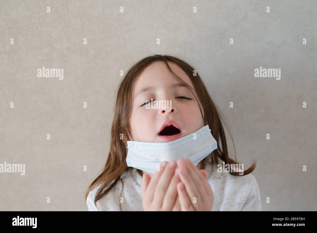 symptoms of coronavirus concept of small little girl sneeze and cough ...