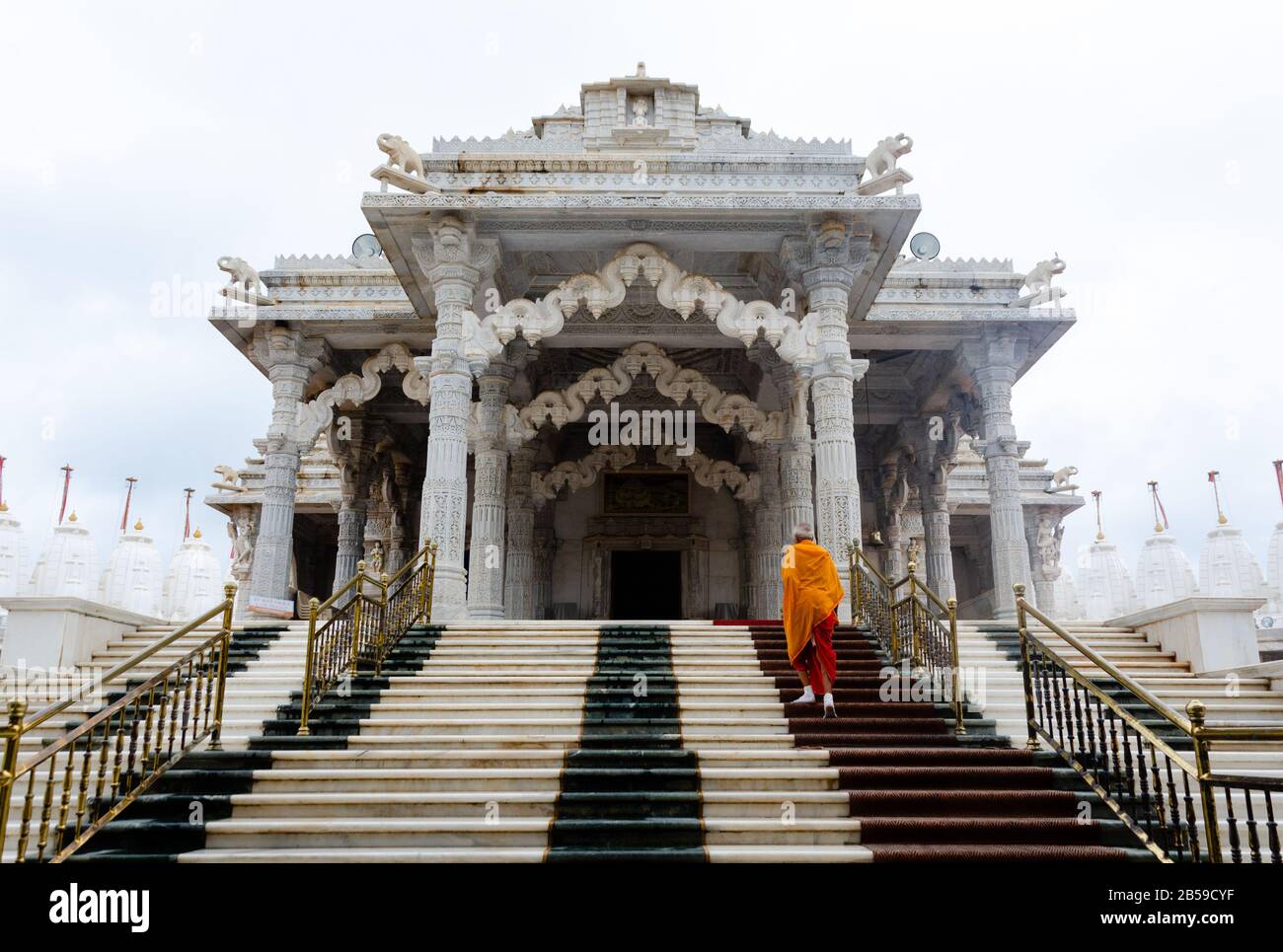 Jain temple priest walking into the entrance of the central temple ...