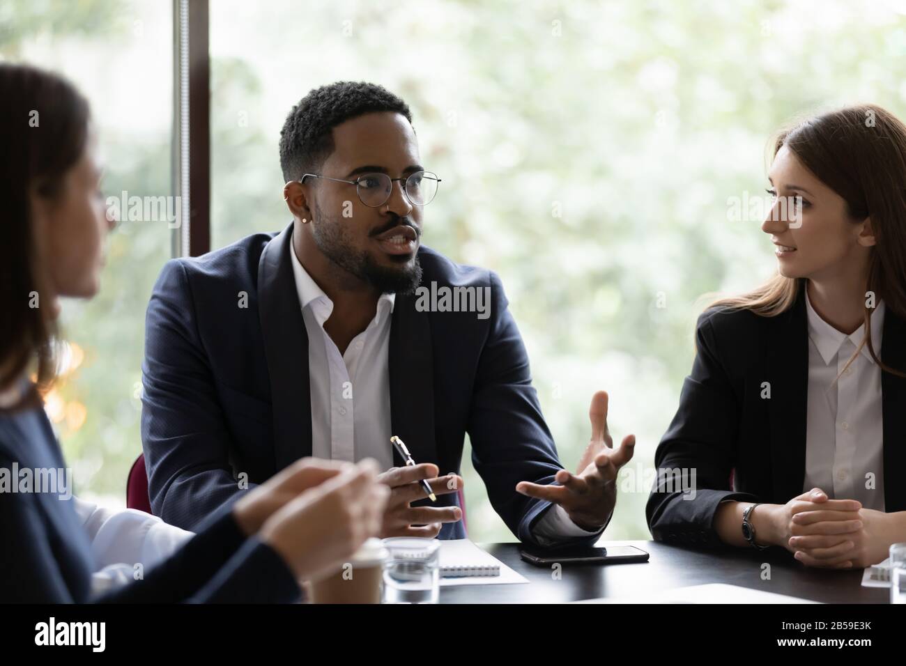 Focused diverse male female colleagues hi-res stock photography and ...