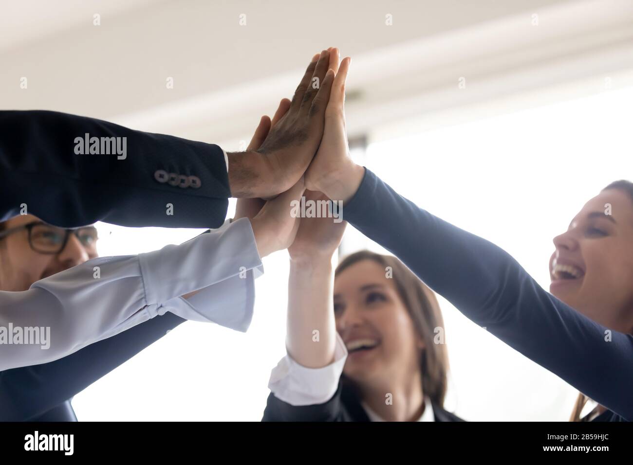 Excited diverse businesspeople give high five celebrate success Stock ...