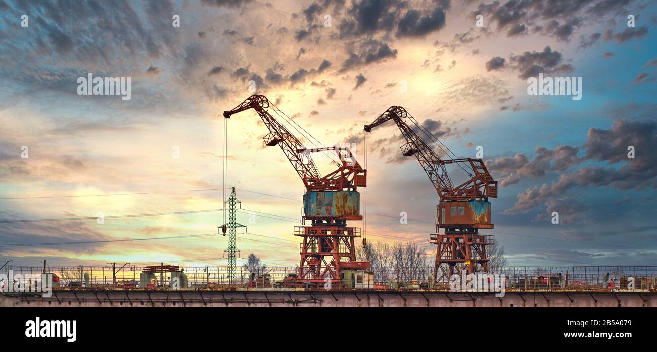 Massive blue, orange and yellow cranes in harbour Stock Photo - Alamy