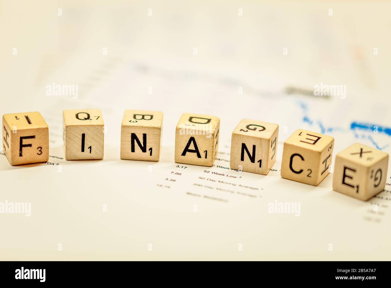 Closeup of word Finance on wooden blocks on stock chart, background ...