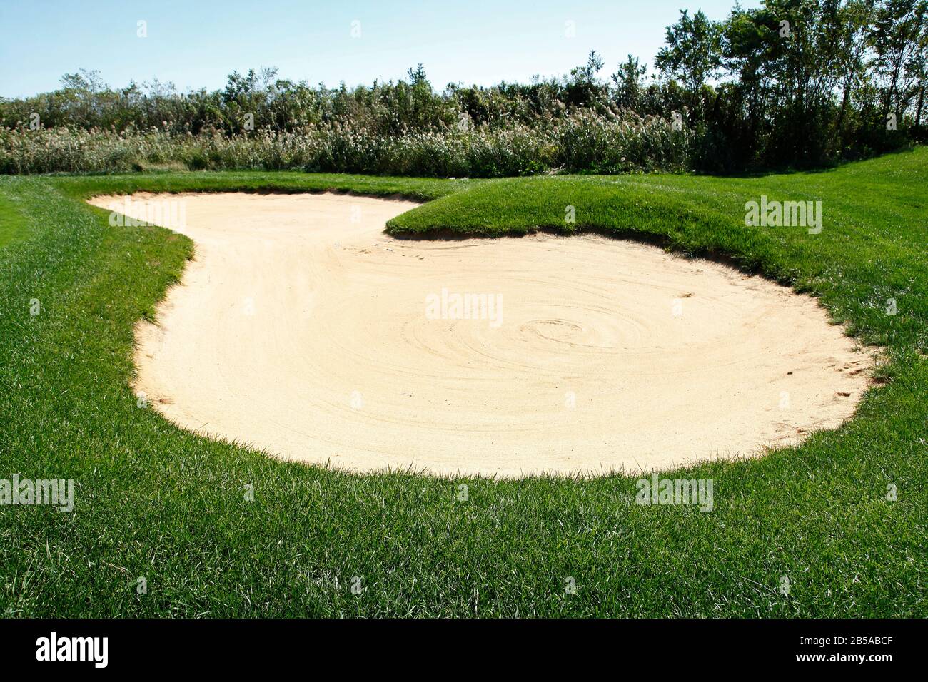 Sand bunker on the golf course Stock Photo - Alamy