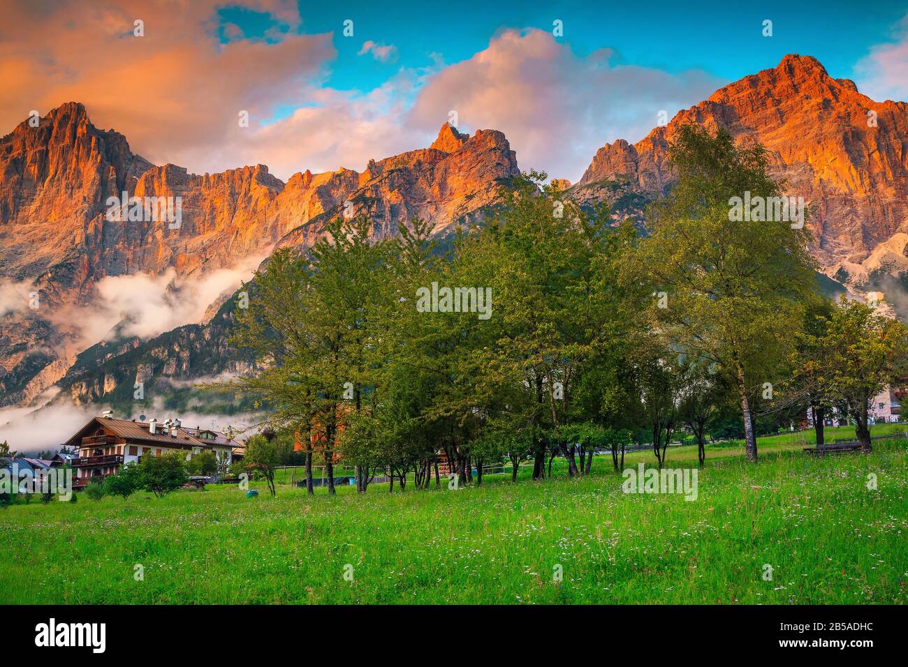 Popular mountain resort in the Dolomites, colorful spring flowers with ...