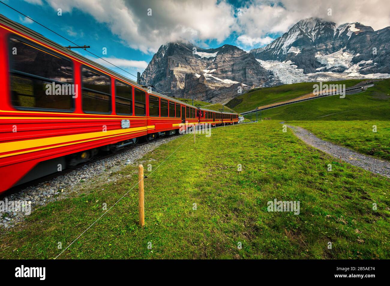 Mountain cogwheel railway with popular electric red tourist train ...