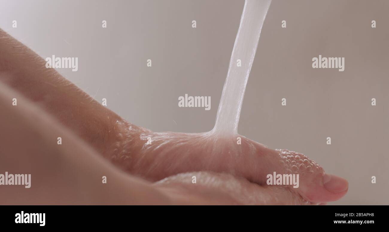 Washing hands under faucet hi-res stock photography and images - Alamy