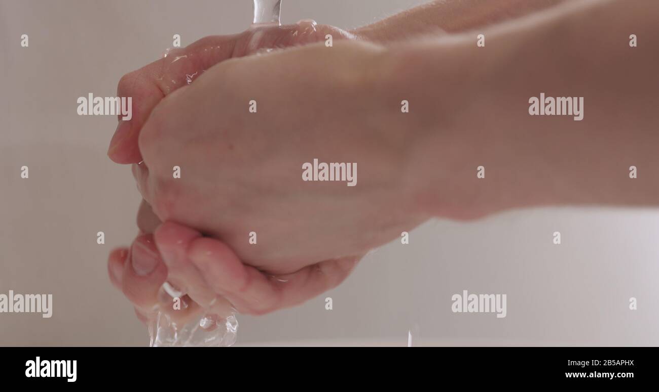 Washing hands under faucet hi-res stock photography and images - Alamy