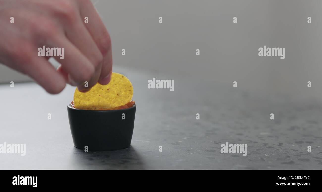 dip round corn chips in salsa closeup, wide photo Stock Photo - Alamy