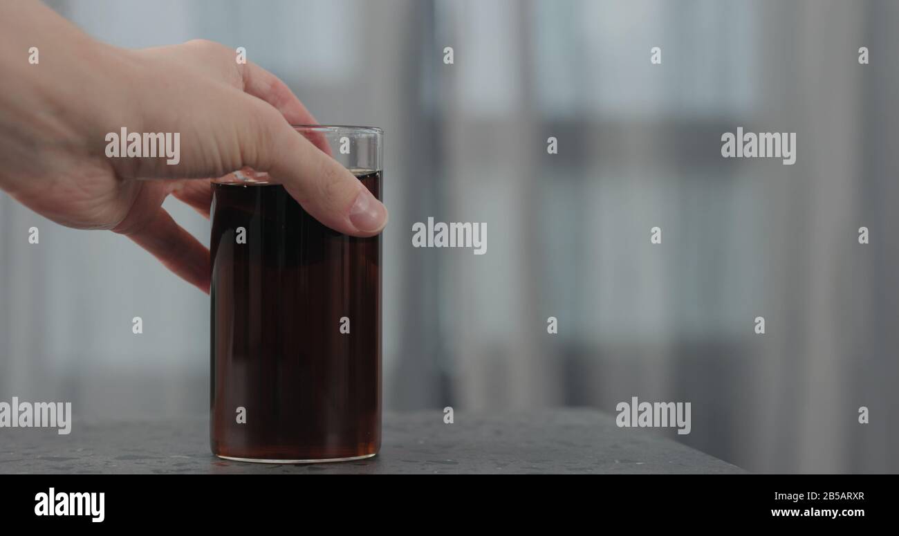 man hand take cola in glass from concrete surface, wide photo Stock ...