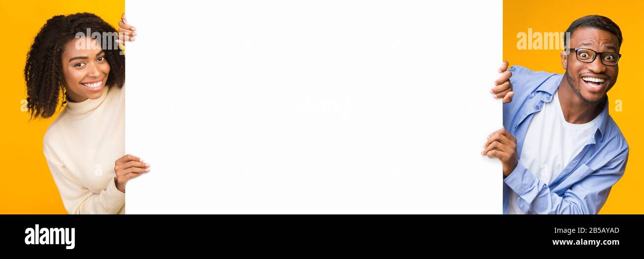 African American girl and man holding white advertising banner on ...