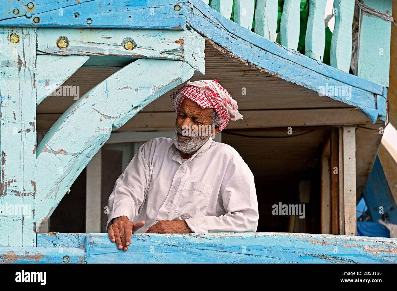 dubai, uae - 2020.02.22: the captain of an arab wooden dhow on his ship ...