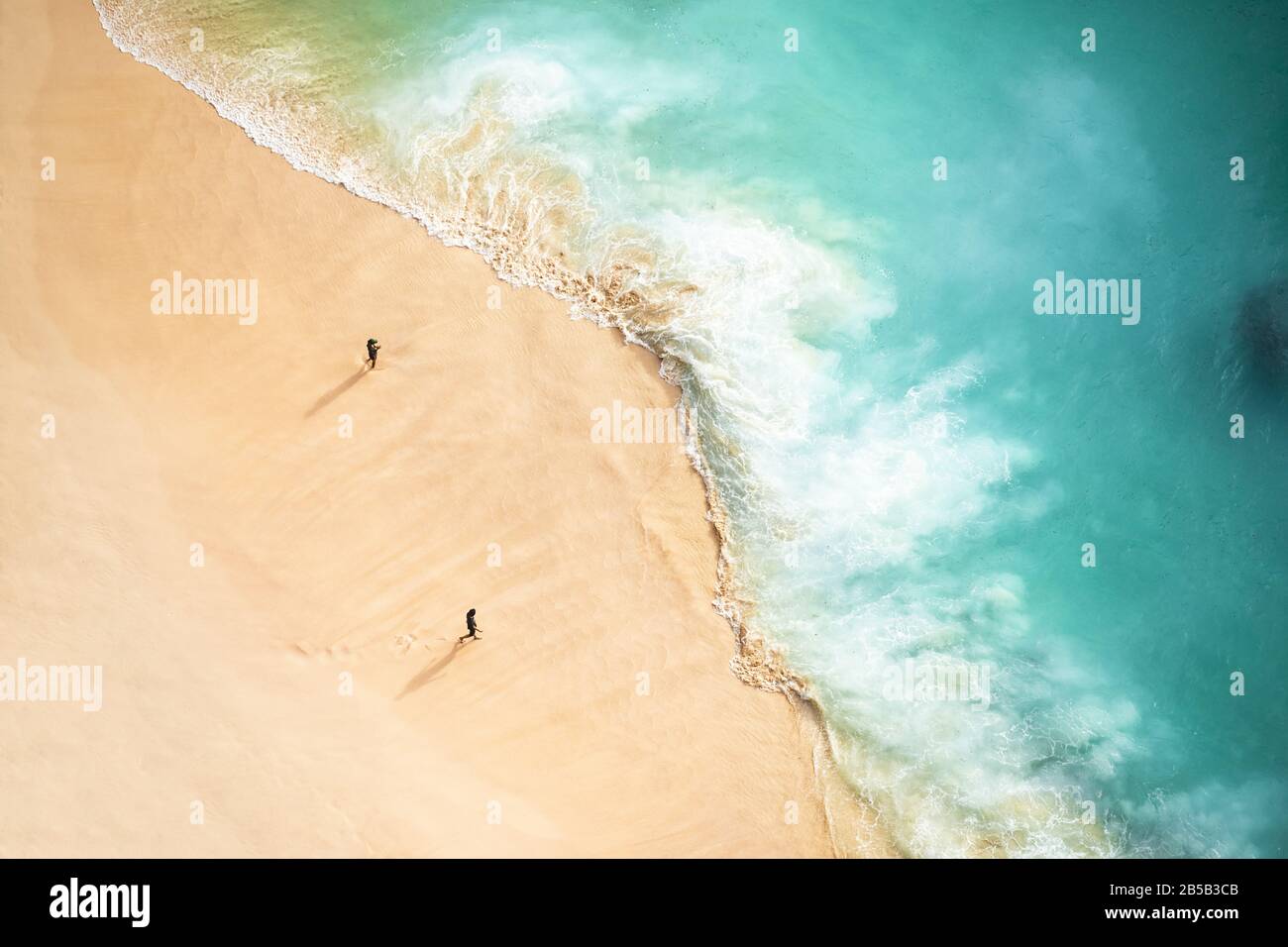 View from above, stunning aerial view of two people walking on a ...
