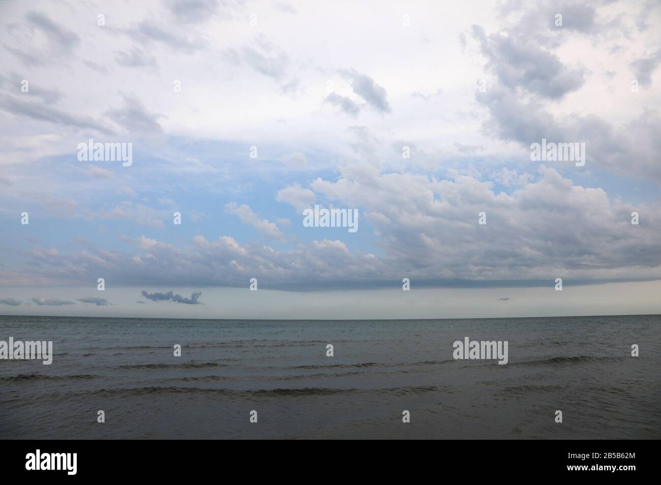 clouds on the blue sky and the calm sea without people Stock Photo - Alamy