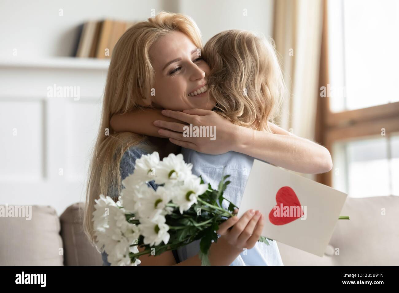 Little caring girl greeting mom with birthday Stock Photo - Alamy