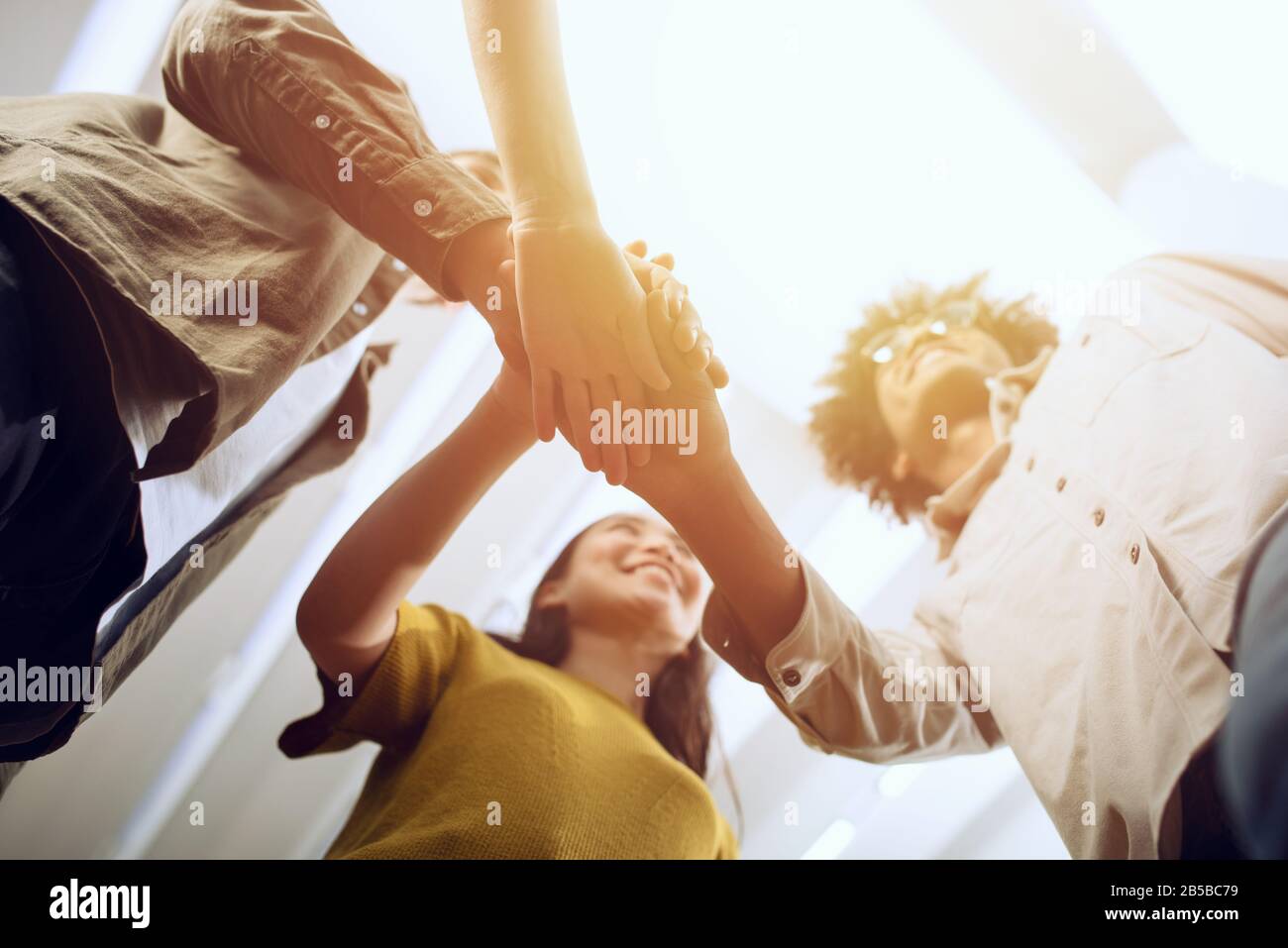 Business people putting their hands together. Concept of teamwork and ...