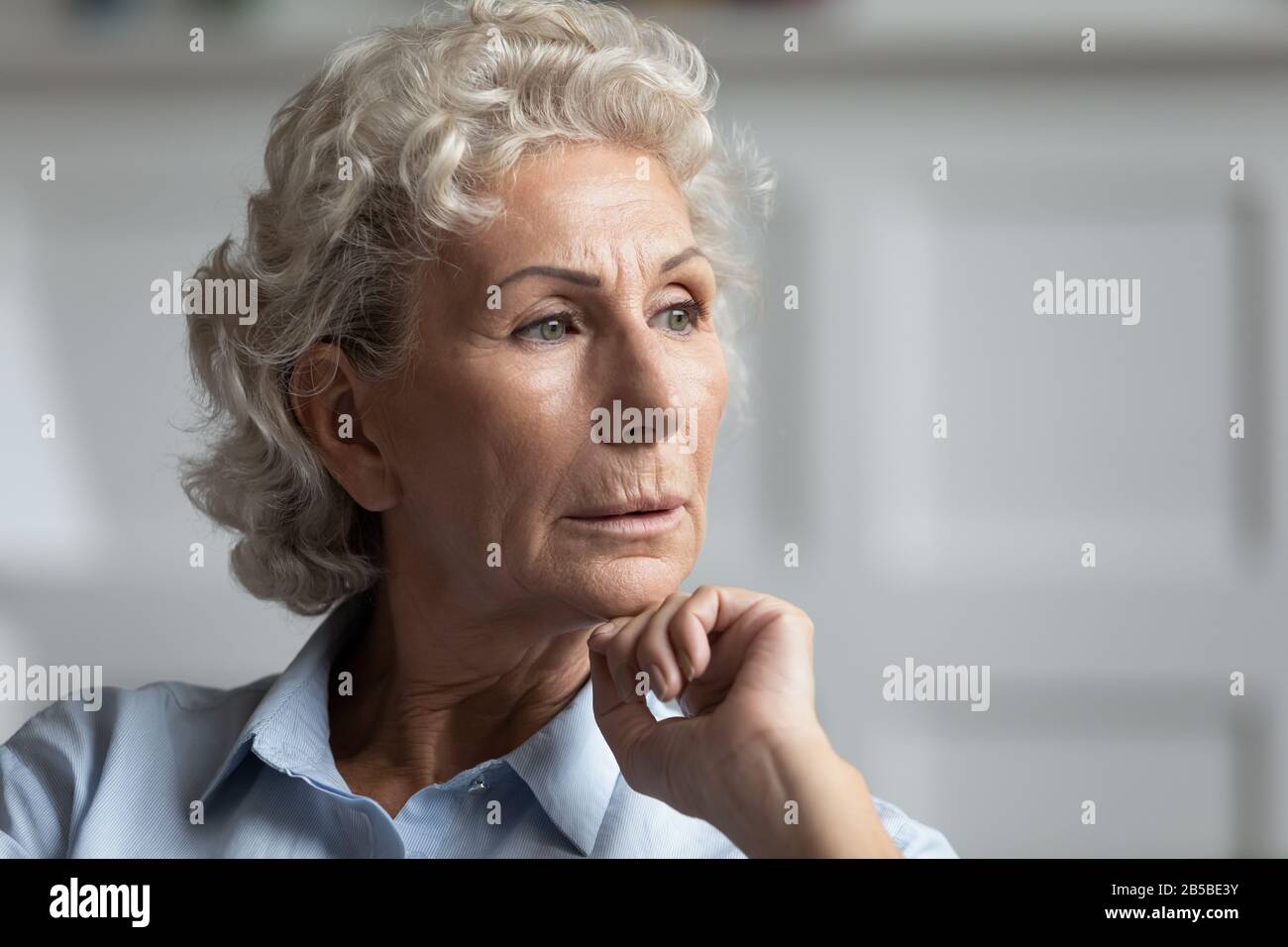 Thoughtful mature woman look in distance feeling lonely Stock Photo - Alamy