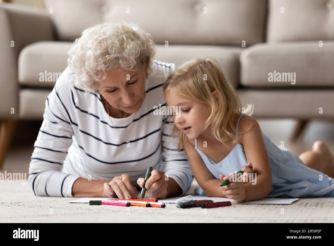 Grandmother caring for child hi-res stock photography and images - Alamy