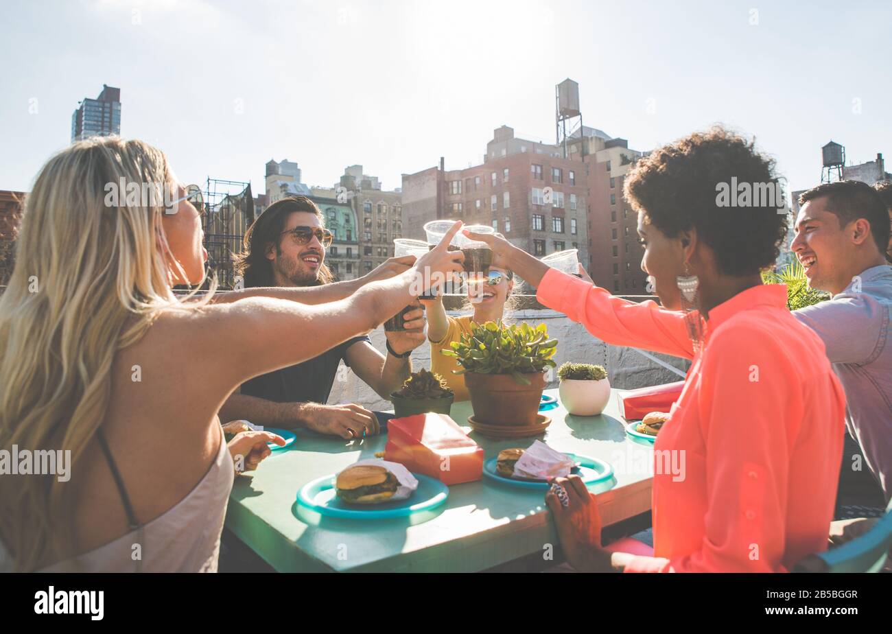 Group of friends apending time together on a rooftop in New york city ...