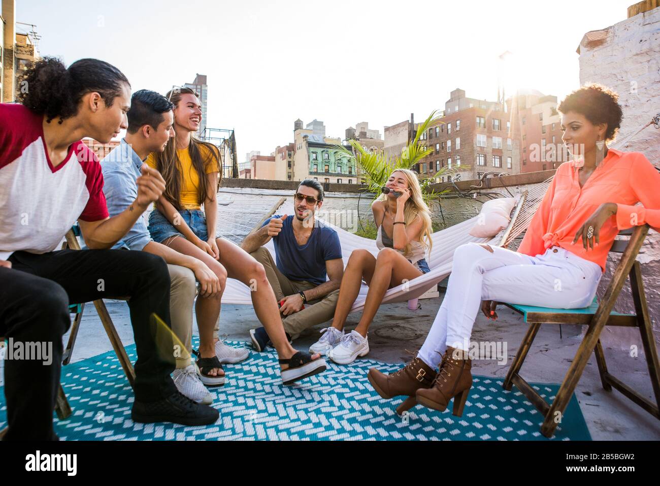 Family sitting on rooftop terrace hi-res stock photography and images ...