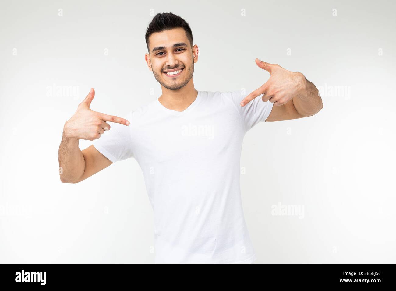 man in a white t-shirt in a blank template on a white studio background ...