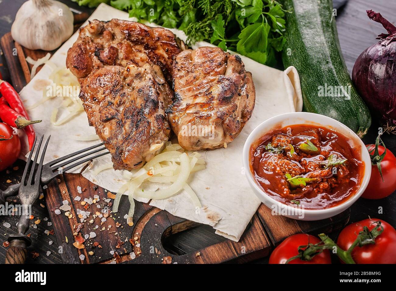 Chicken kebab on pita bread. Food still life with meat, sauces ...