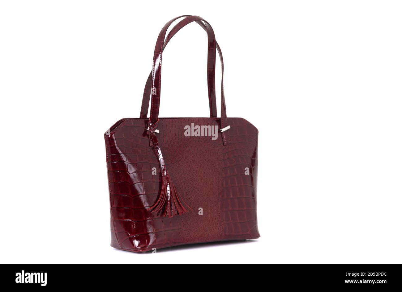 expensive red female leather bag on a handle isolated on a white ...