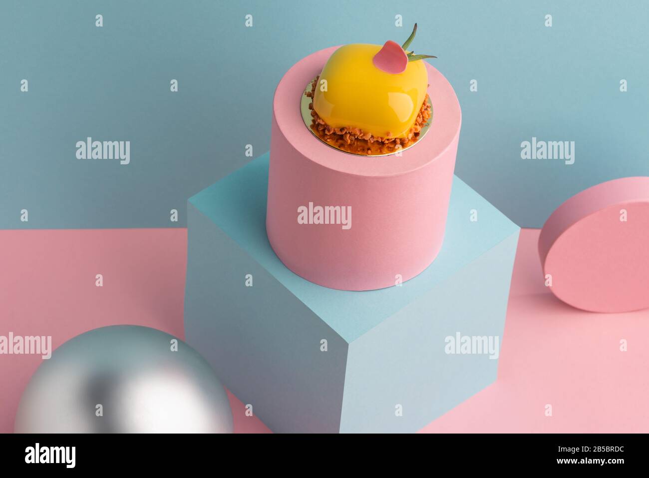 Bright yellow mousse cake with pink chocolate and rosemary Stock Photo ...