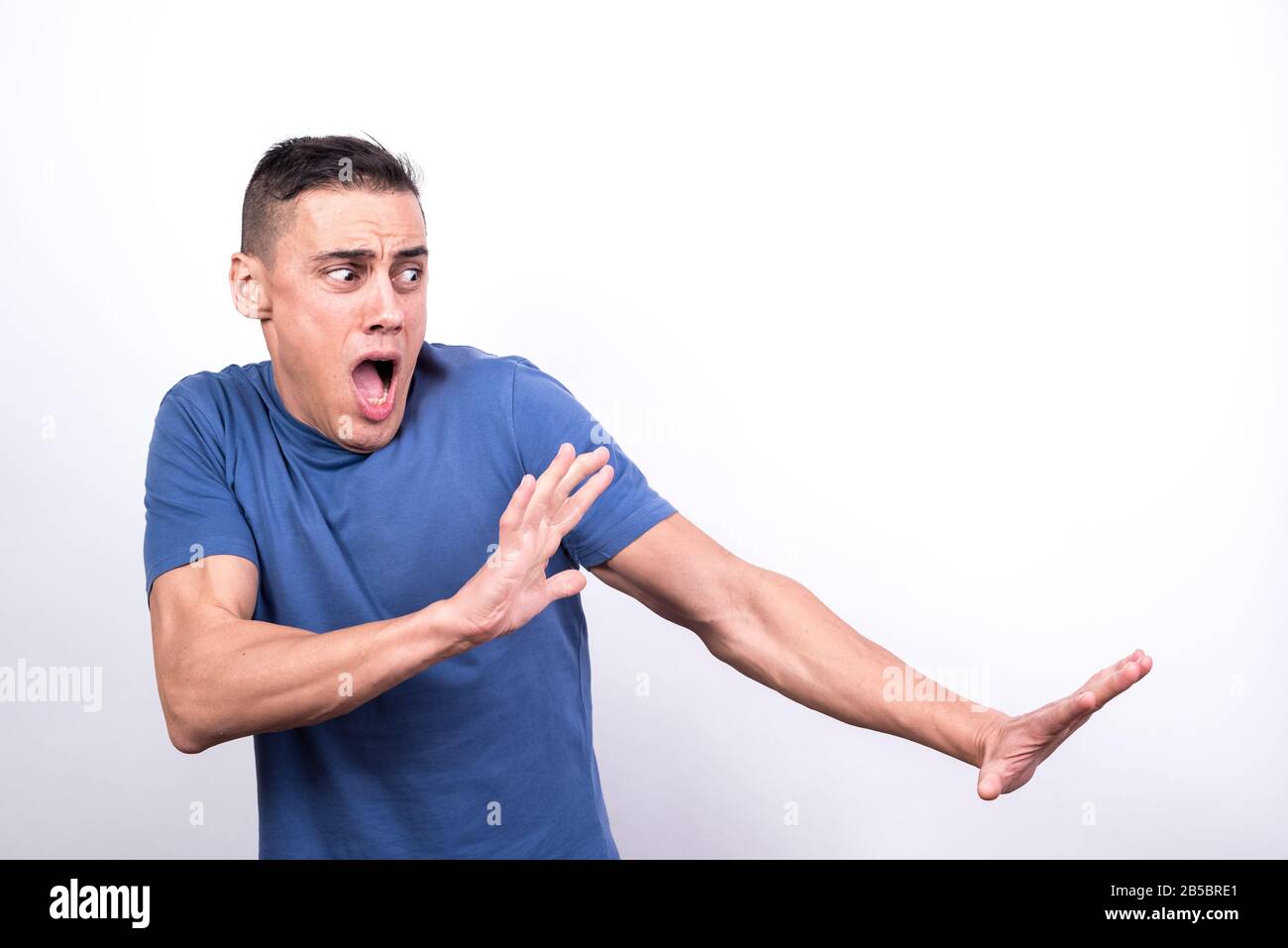 Scared man on white background, medium shot Stock Photo - Alamy