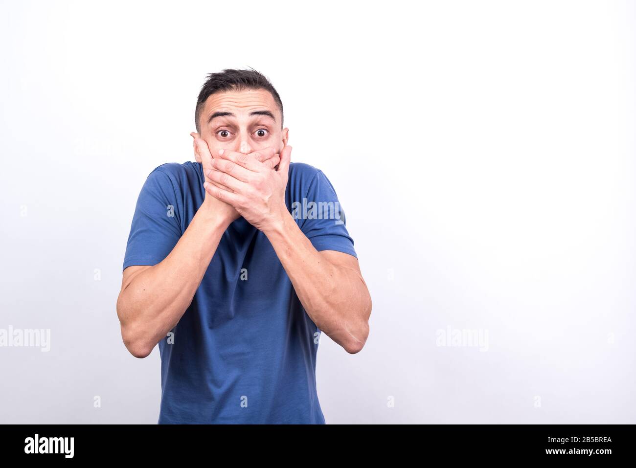 Man covering his mouth with his hands because he said something ...